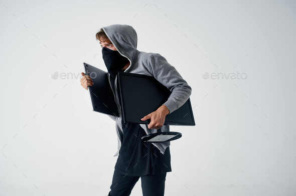 masked man hooded head hacking technology security light background Stock Photo by shotprime
