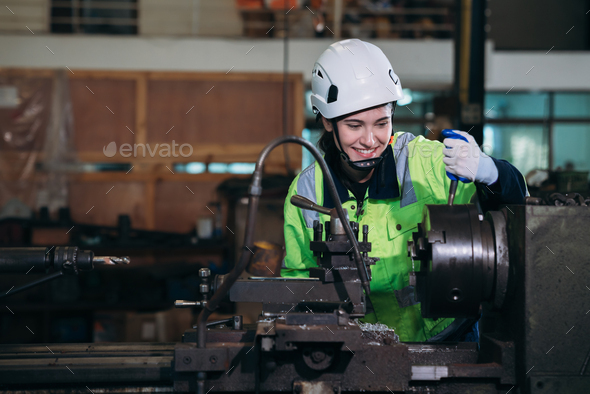 Industrial worker inspecting and check up machine at factory machines ...