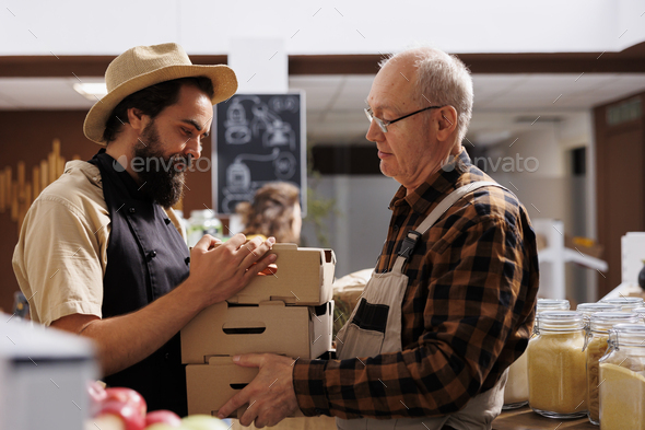 Old man providing vegetables to merchant Stock Photo by DC_Studio ...