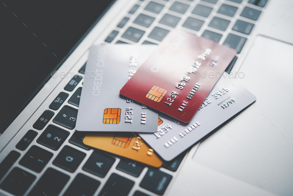 Many credit cards are placed on the keypad. laptop.Online payment for ...