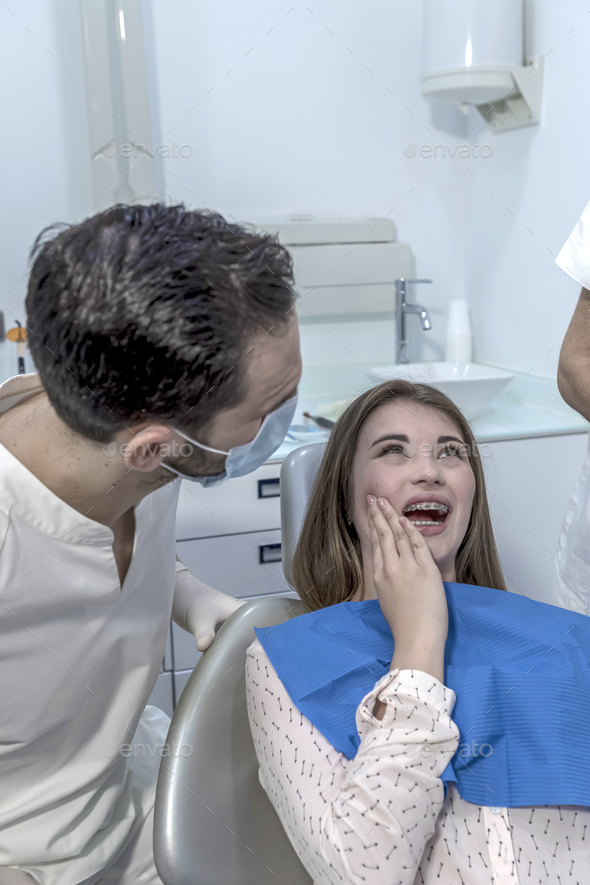 little woman with teeth pain looking sadness on his dentist Stock Photo ...