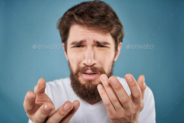 Bearded man displeased facial expression emotions close-up blue ...