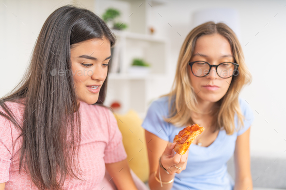 Concentrated students eating pizza while doing homework at home Stock ...