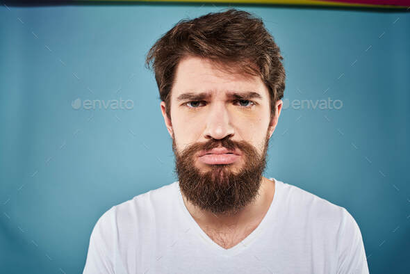 Bearded man displeased facial expression emotions close-up blue ...