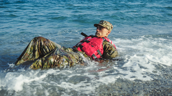 Military man with camouflage and life jacket as safety concept Stock ...