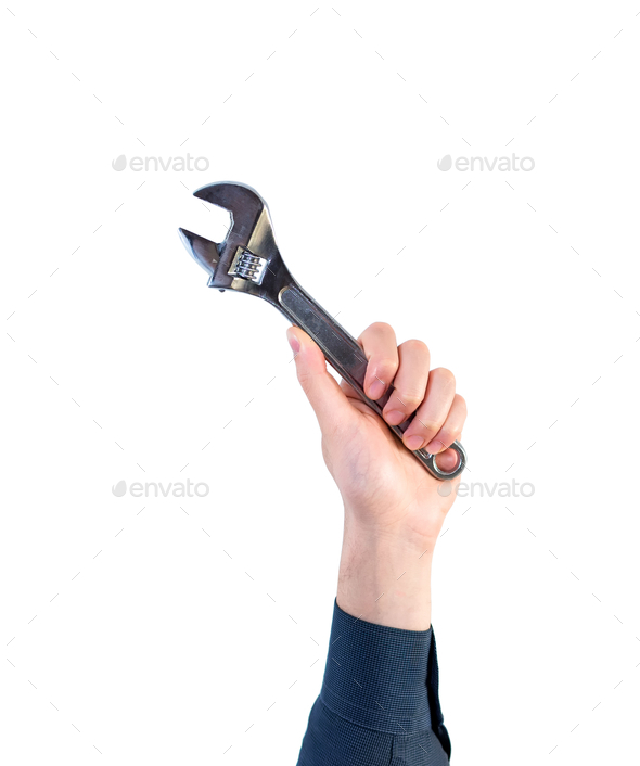 Man's arm raised holding an adjustable spanner isolated on white ...