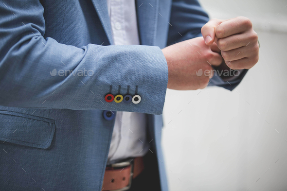 Shallow focus of a man in a suit fixing a watch on his wrist Stock ...