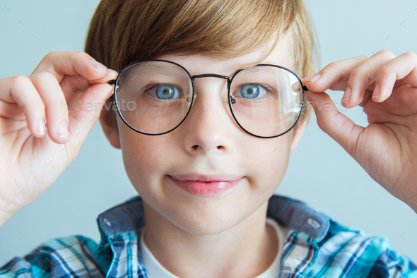 Little boy wearing glasses at ophthalmologist's office. Boy child kid ...