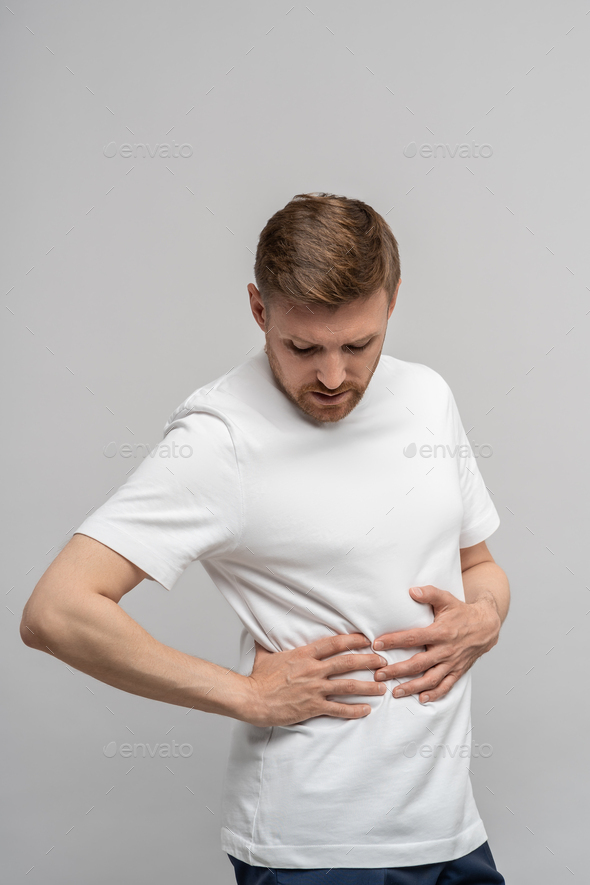 Man having health problems feeling pain spasms in right part of body on ...