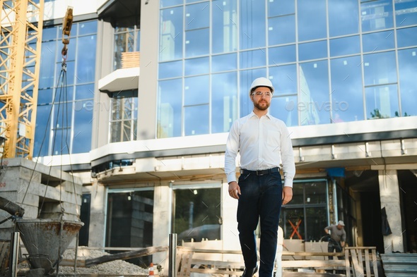 Engineer next to building cranes. Concept - large construction project ...