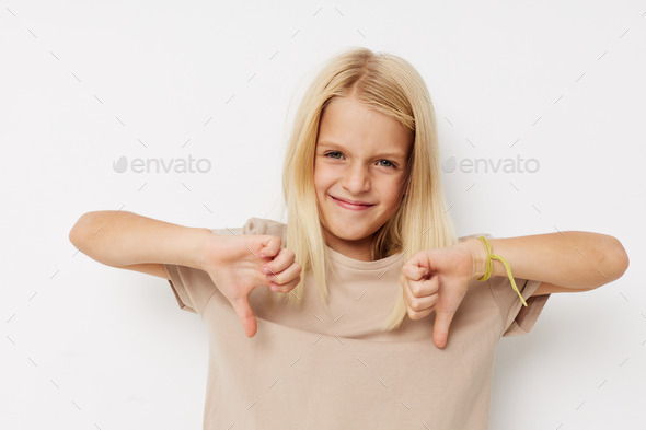 Positive little girl hand gesture fun fashion posing studio Stock Photo ...