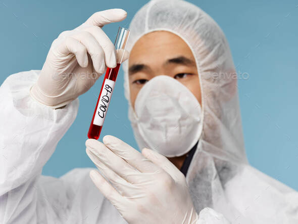 Man of Asian appearance Laboratory blood test diagnostics close-up blue ...
