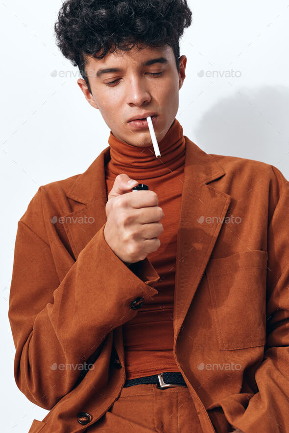 Man sitting smiling cigarette fashion lifestyle smoking beige portrait ...