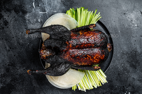 Traditional whole roasted Christmas Peking duck with herbs and sauce ...