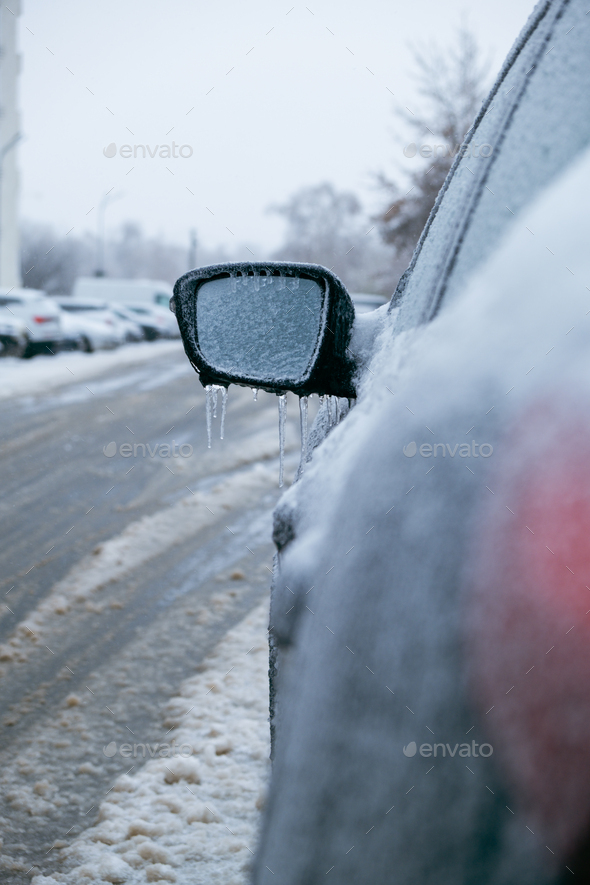 car covered with ice after snowstorm Stock Photo by petruninsphotos