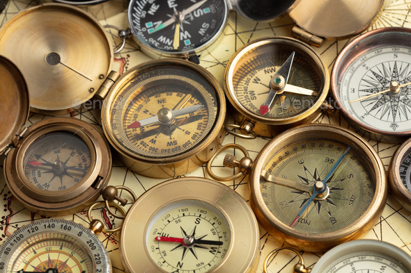 Different compasses on old map Stock Photo by Alex_star | PhotoDune