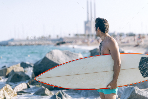 Handsome surfer holding his surfboard Stock Photo by raferto1973 ...