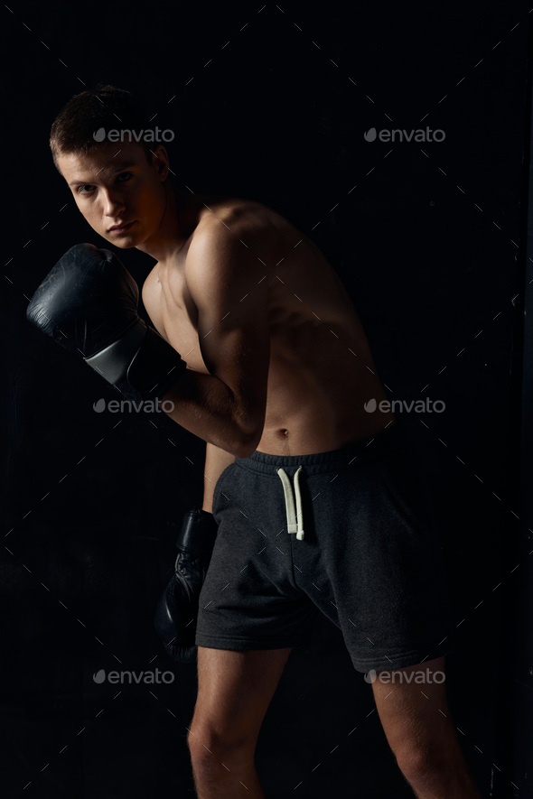 bodybuilder wearing boxing gloves black background cropped view sport ...