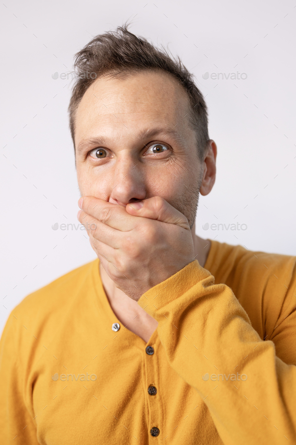 Portrait of a young man with shocked facial expressions isolated on ...