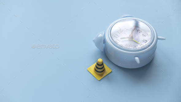 Fixing, maintenance and under construction concept. Alarm clock with ...