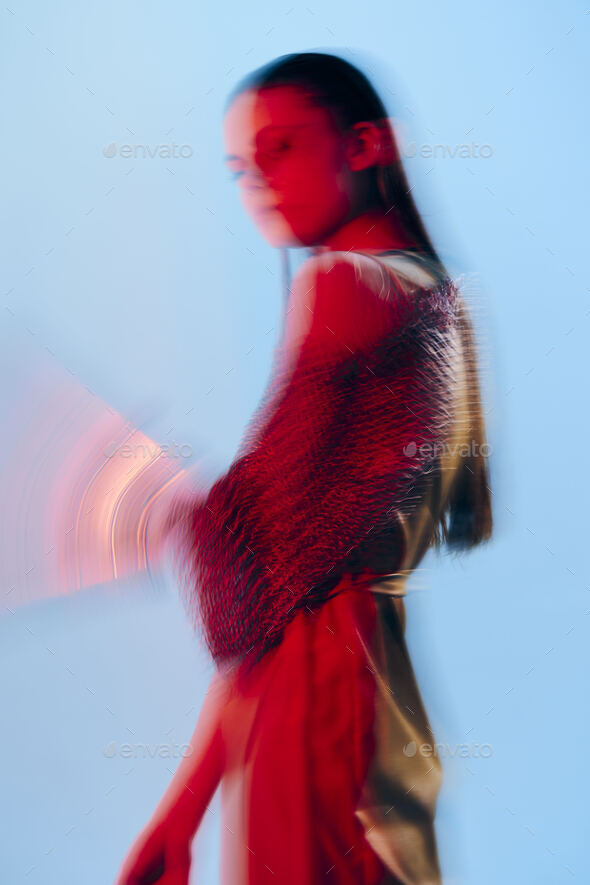 photo pretty woman Glamor posing red light metal armor on hand isolated ...