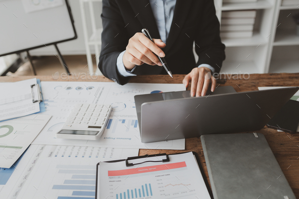 Accountant calculating numbers on calculator, Auditor is working on ...