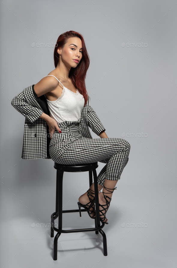 Shoot with red hair woman and black and white checkered suit and high ...