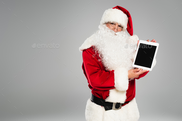 Santa claus in costume holding digital tablet with blank screen ...