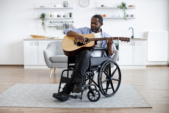 Cheerful smiling african person with disability holding string ...