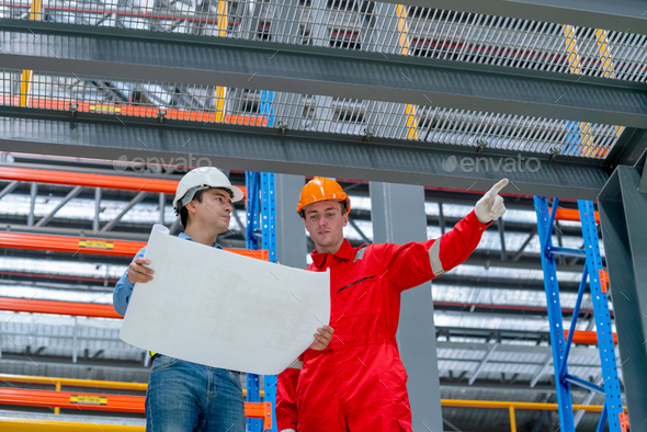Close up and lower view engineer hold drawing plan and technician ...
