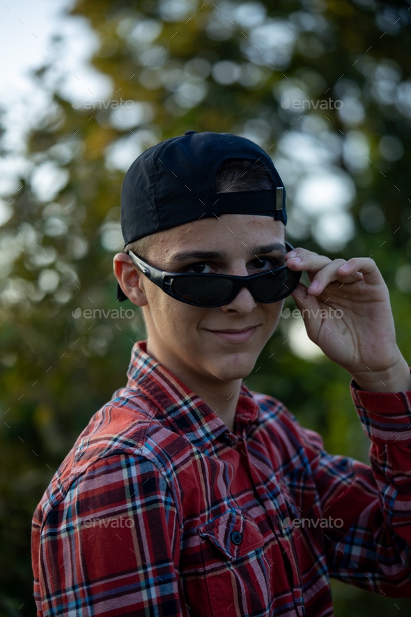Teenage boy standing in rural area in front of his house Stock Photo by ...