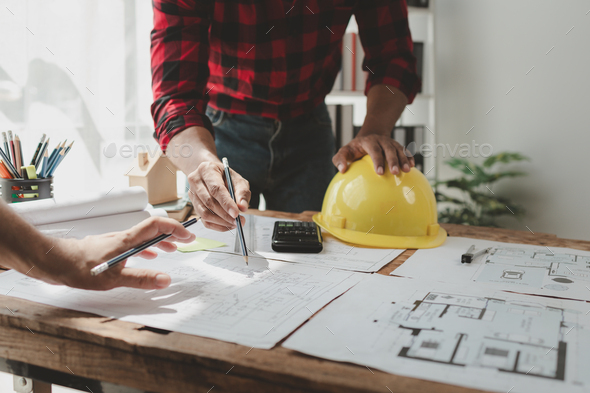 engineer is in planning meeting with architect about building a house ...