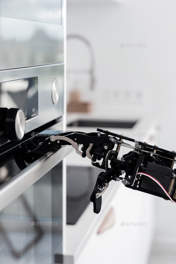 Real robot's hand and electric oven. Concept of robotic process ...
