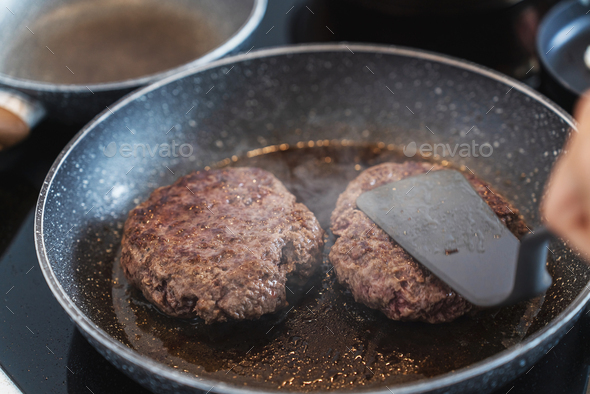 Juicy ground beef hamburger patty sizzling and cooking to perfection ...