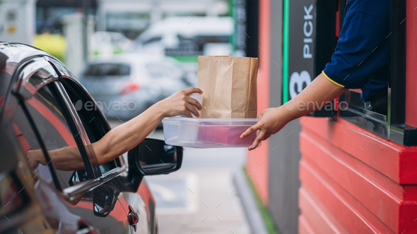 Young Man receiving coffee at drive thru counter., Drive thru and take ...