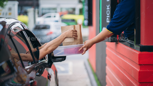 Young Man receiving coffee at drive thru counter., Drive thru and take ...