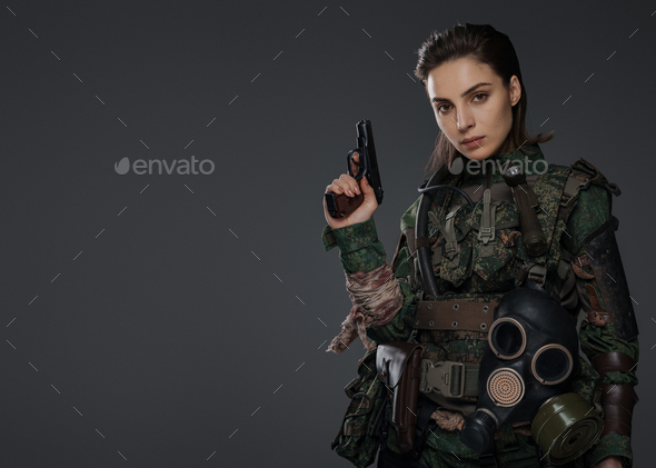 Female warrior dressed in military garb, armed with a pistol Stock ...