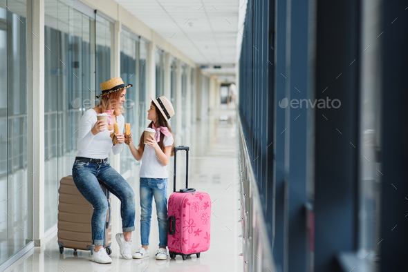 Traveling and flying with children. Mom with baby at boarding airplane ...