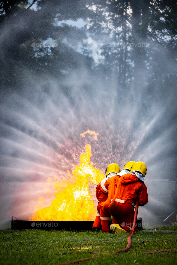 Firefighter Concept. Fireman using water and extinguisher to fighting ...