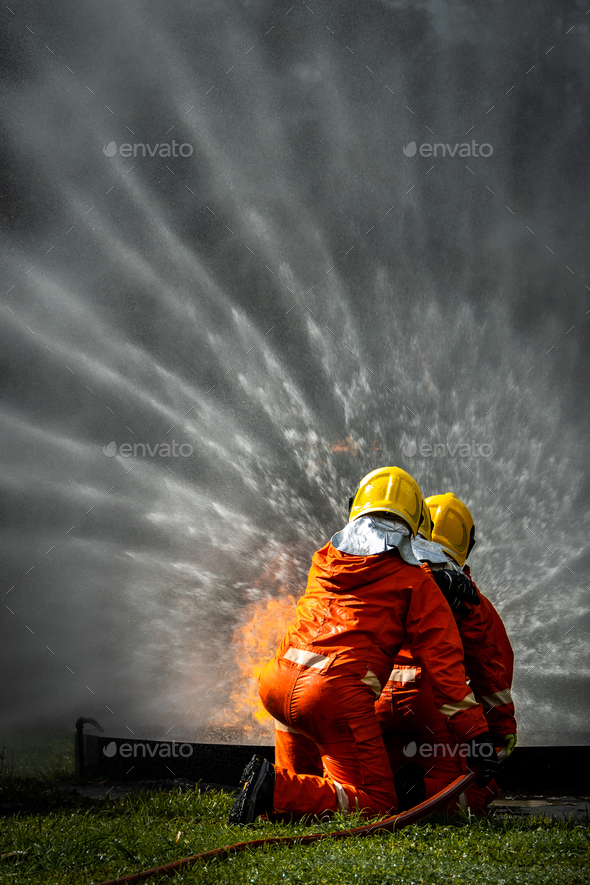 Firefighter Concept. Fireman using water and extinguisher to fighting ...