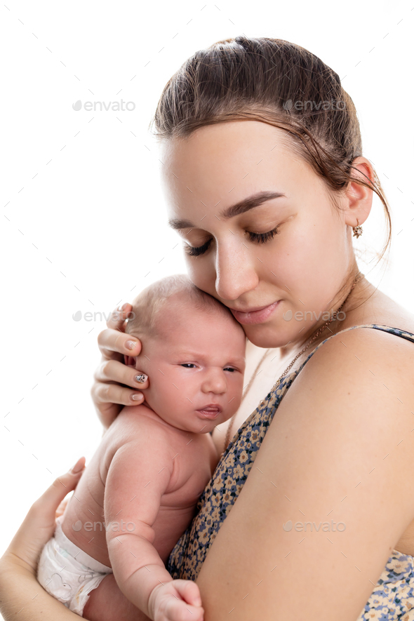 Mother holding her newborn baby on a white background. Baby care. Stock ...