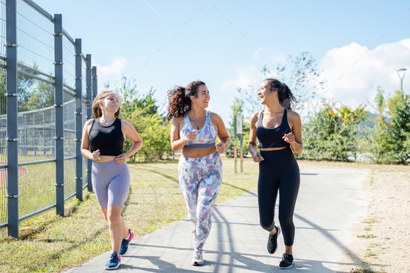 College girls running in running track on campus.Training for athletic ...