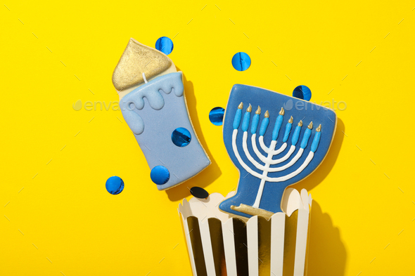 Gingerbread cookies with Jewish signs and popcorn paper bag on yellow ...