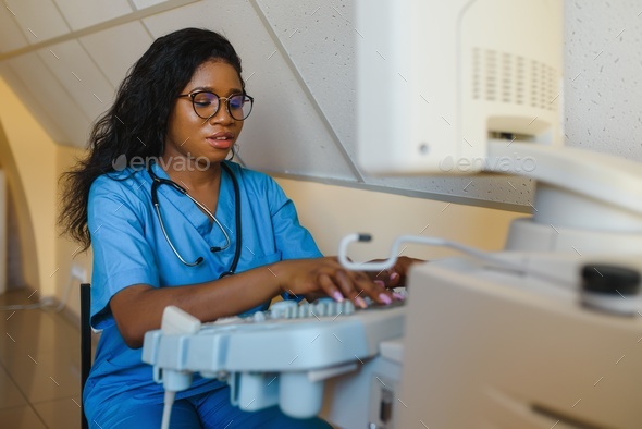 African woman doctor with ultrasound scanner in hand, working on modern ...