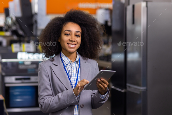 Portrait successful female salesperson in a large home appliance store ...