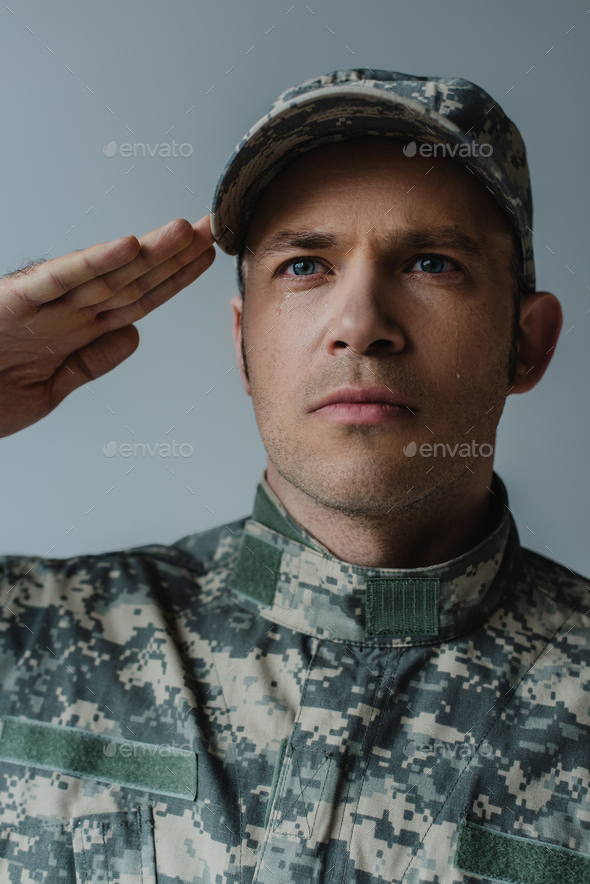 sad soldier in military uniform crying and saluting during memorial day ...