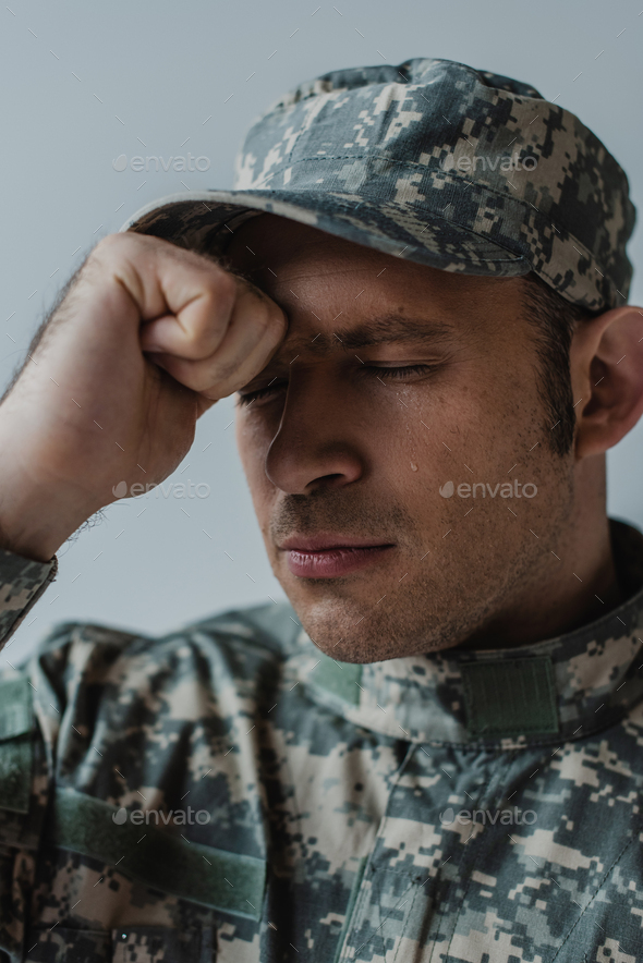 sad soldier in military uniform crying with closed eyes during memorial ...
