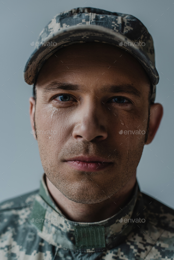portrait of sad soldier in military uniform crying during memorial day ...