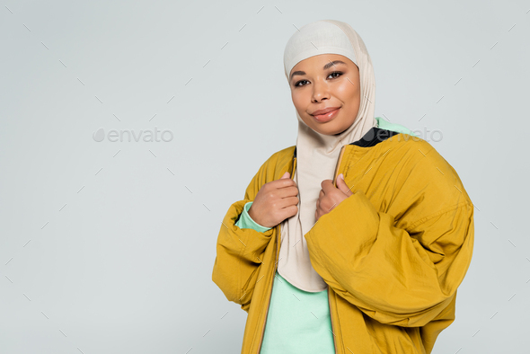 muslim multiracial woman smiling at camera while posing in hijab and ...