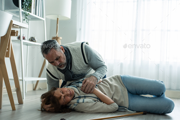 Caucasian senior woman fall on the ground while walk with walker alone ...
